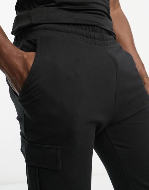 Threadbare Fitness slim fit cargo trackies in black | ASOS