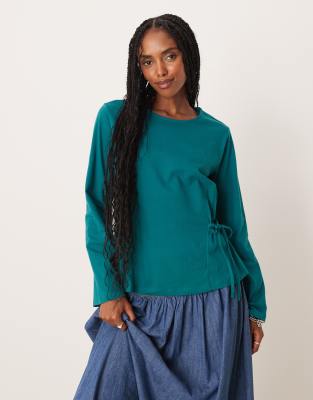 Top color cerceta de manga larga con cintura ceñida y lazada lateral de ...