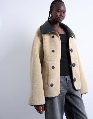 Shearling oversized reversible coat with button loop in black and cream ...