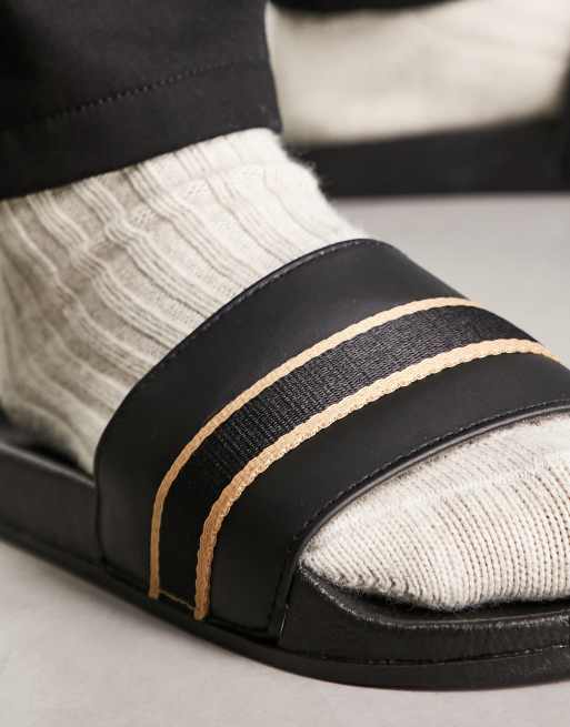 Truffle Collection gold print sliders in black | ASOS