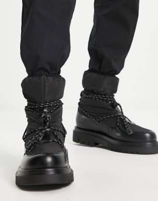 Truffle Collection pull on drawstring snow boots in black faux leather | ASOS